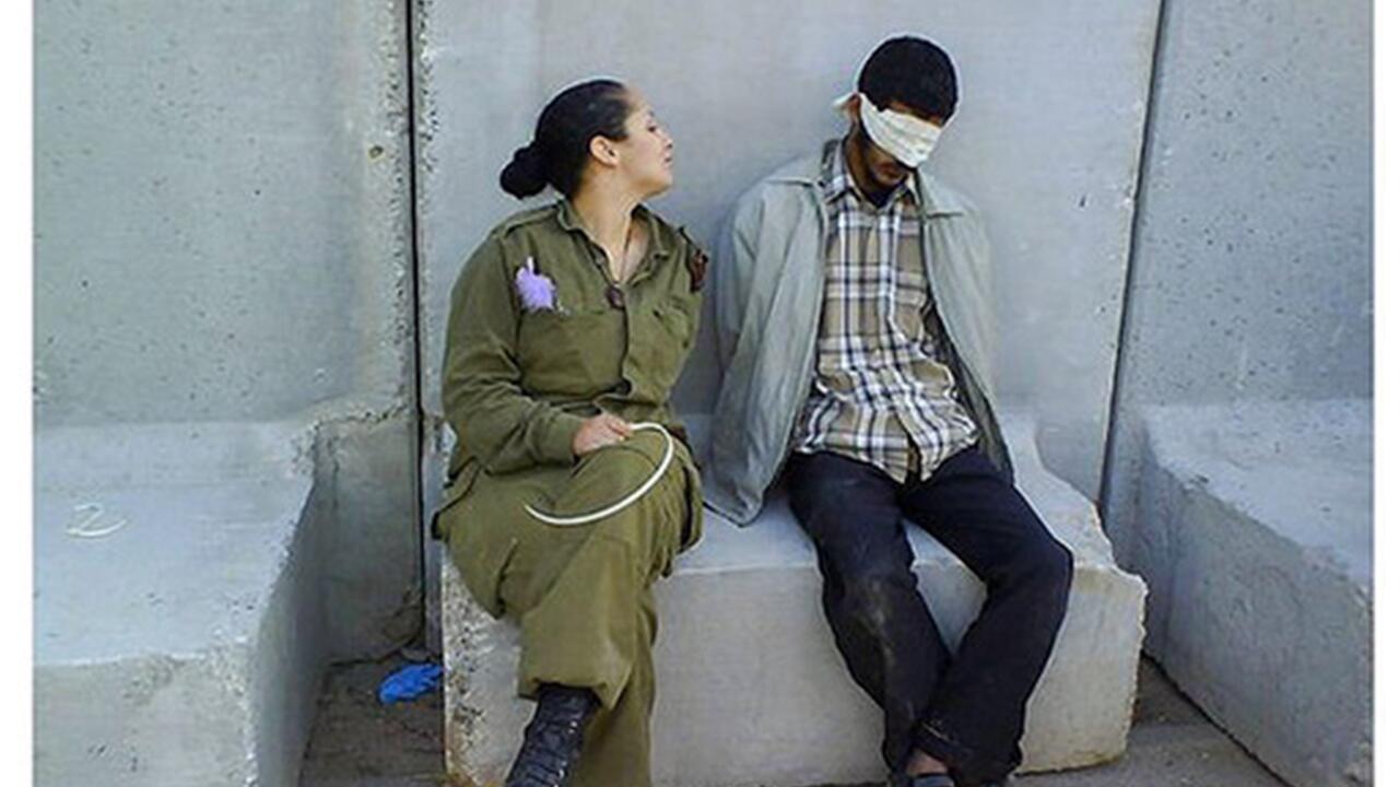 Former Israeli soldier poses with Palestinian prisoners